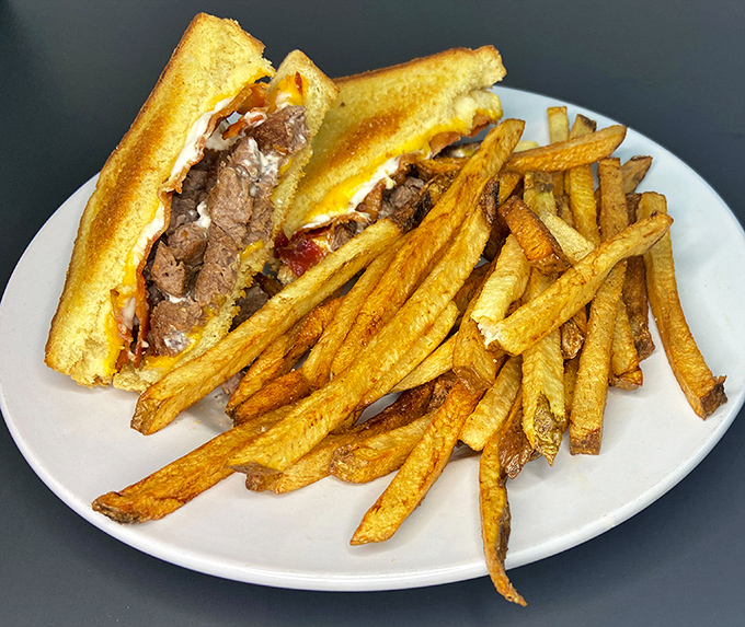 This isn't just a sandwich&mdash;it's a masterpiece of melted cheese and tender steak that makes you want to high-five the chef.