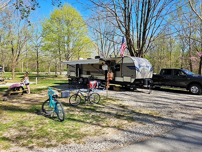 The modern nomad's setup: RV, bicycles, and the essential American flag. Home is wherever you park it in Harmonie's spacious campsites.