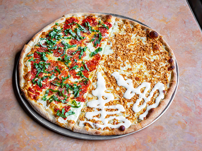 Half red sauce, half white sauce&mdash;this pizza doesn't believe in picking sides. The charred crust edges tell the story of proper wood-fired technique. 