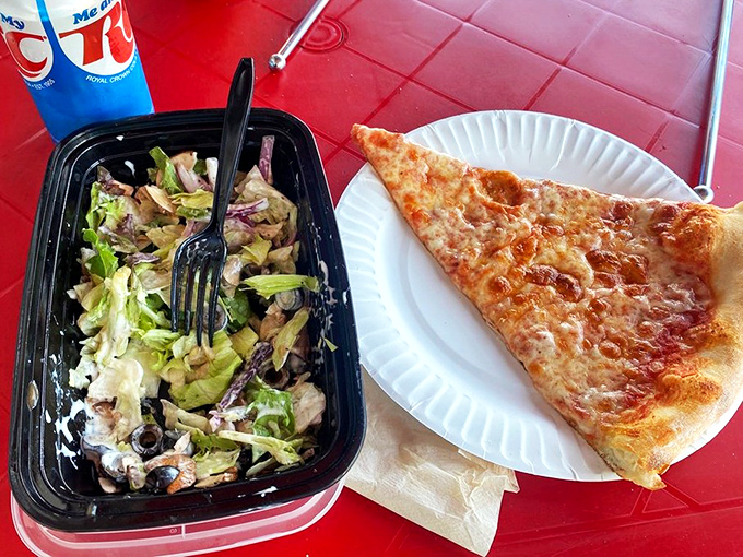 The classic New York lunch combo: a perfect triangle of cheese pizza and a fresh salad. Simple pleasures that somehow taste better in paper plates.