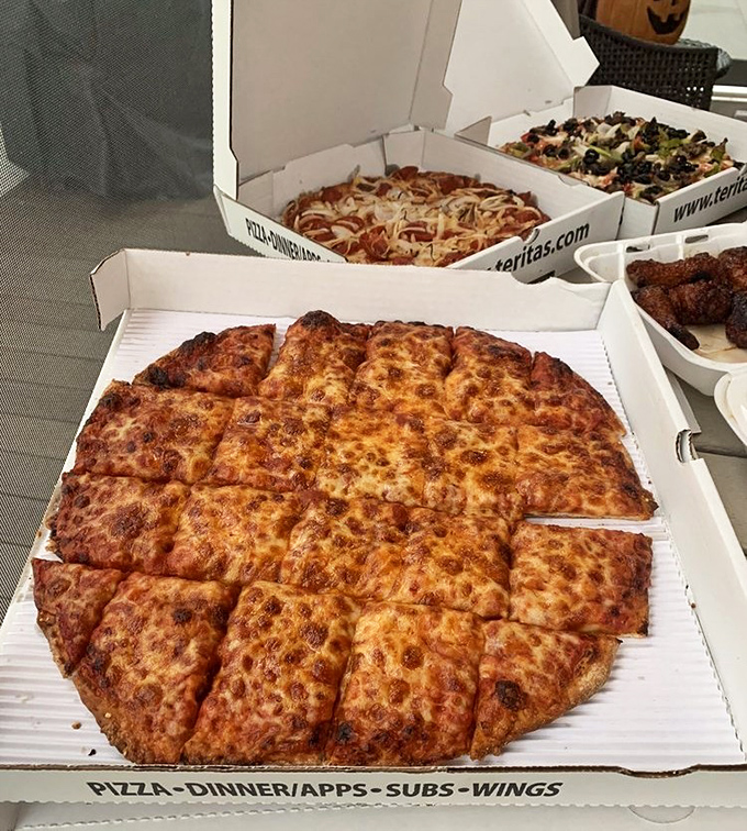 The holy trinity of Terita's boxes &ndash; cheese, specialty, and wings. Not pictured: the willpower required to make it home without sneaking a slice.