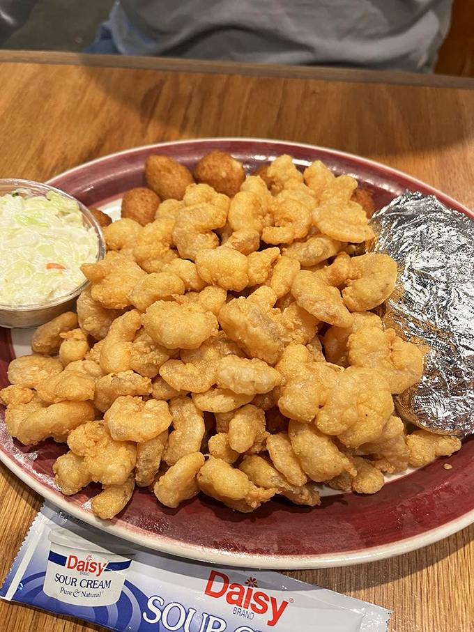 Golden-fried popcorn shrimp piled high like delicious treasure&mdash;proof that sometimes the best seafood comes in small, crispy packages.