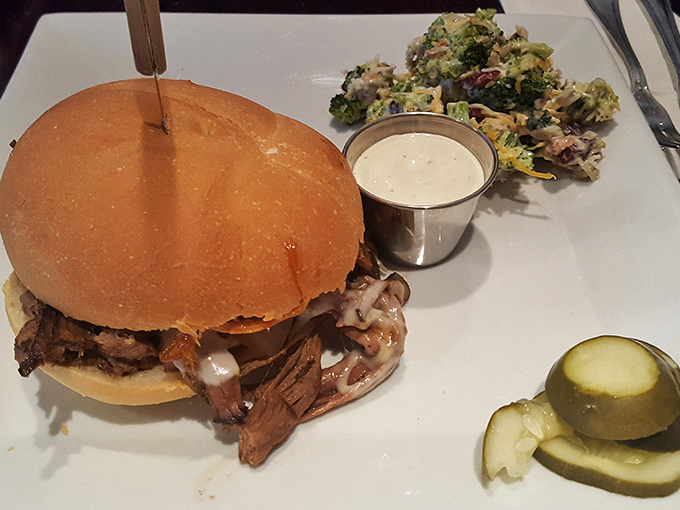 A proper pulled pork sandwich should require both hands and several napkins. This beauty, with its generous heap of tender meat, delivers on that sacred promise.