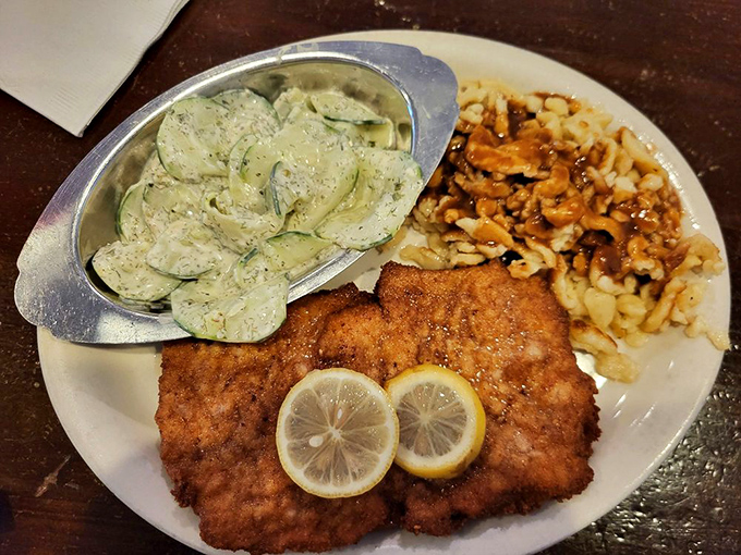 Golden-brown schnitzel that crackles with each fork touch, served with cucumber salad and spätzle – proof that perfection needs no passport.