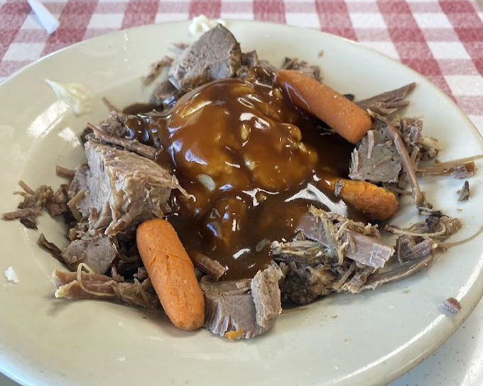 Pot roast that's had a long, meaningful relationship with gravy. Those carrots aren't garnish &ndash; they're witnesses to meat perfection.
