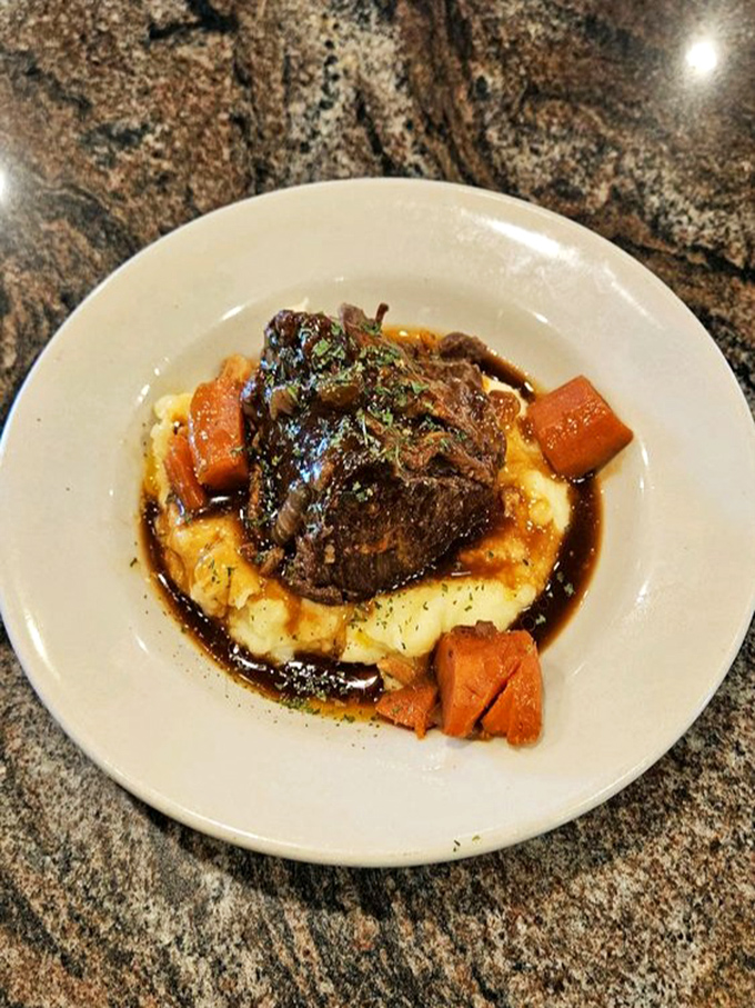 Pot roast so tender it practically surrenders to your fork, nestled on a cloud of mashed potatoes. Sunday dinner any day of the week.