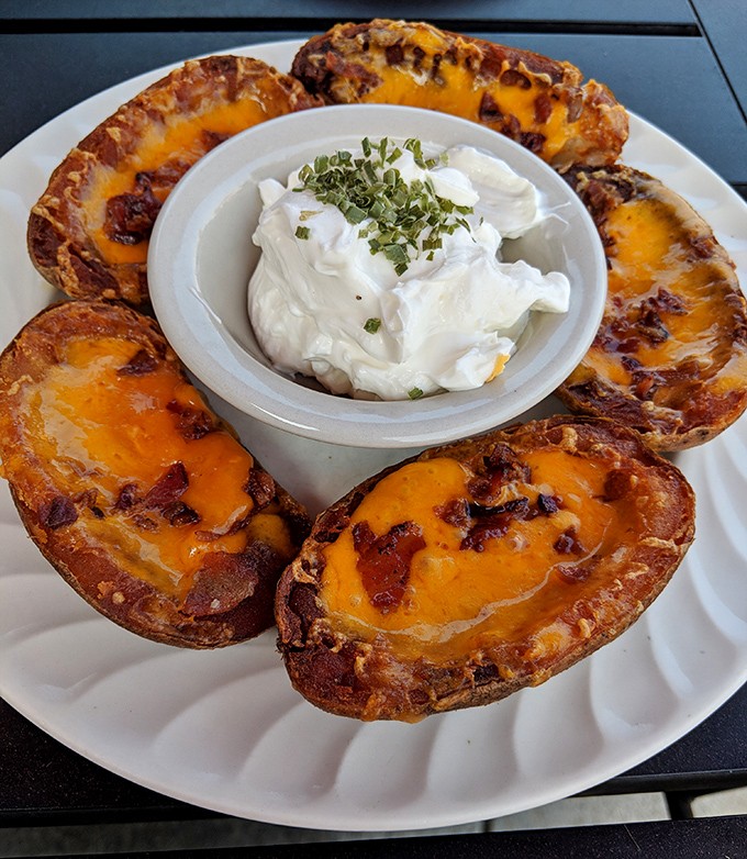 Potato skins with a crown of sour cream&mdash;the kind of appetizer that makes you wonder why you'd ever waste stomach space on main courses.