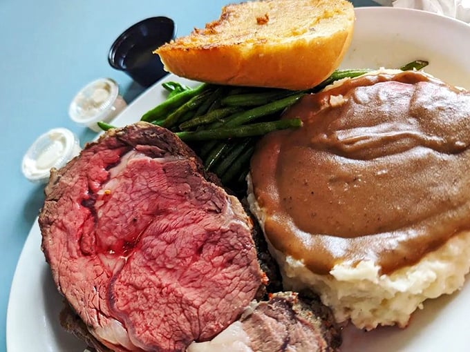 Prime rib so perfectly pink it could make a vegetarian weep, alongside mashed potatoes that clearly never came from a box. Sunday dinner perfection.