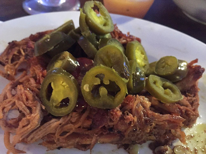 Pulled pork topped with jalape&ntilde;os&mdash;a spicy hat for a flavorful dance partner. This isn't just meat; it's a textural masterpiece of smoky threads.