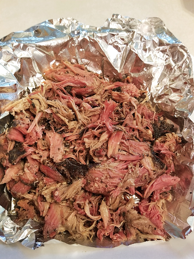Pulled pork so tender it practically surrenders before you even pick up your fork to attack.
