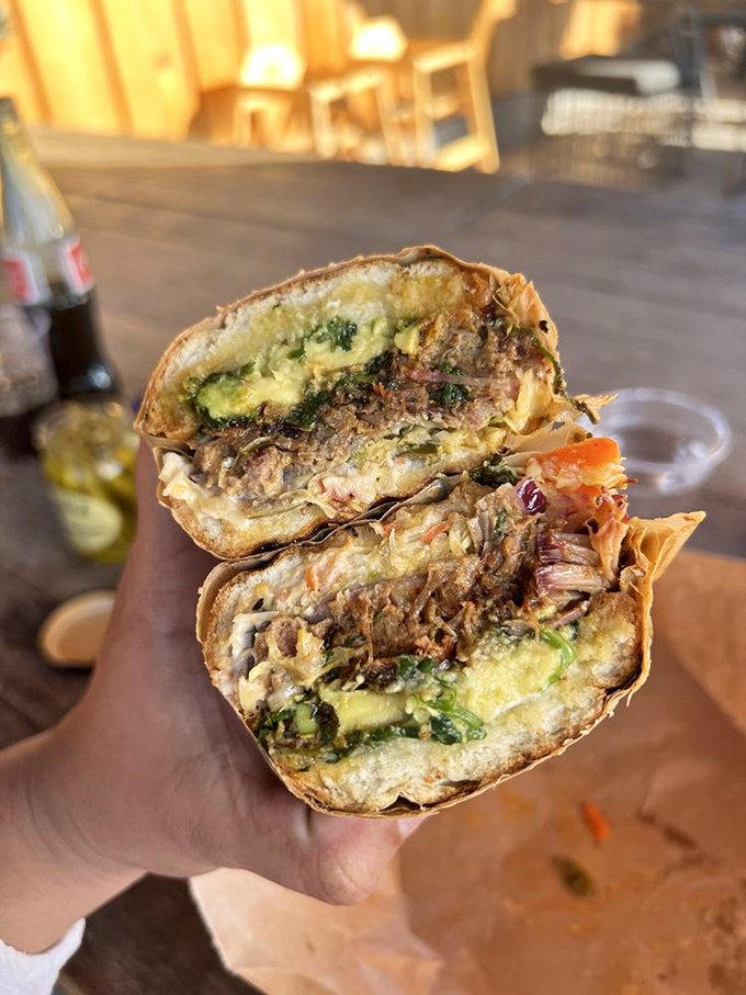 The pulled pork sandwich glistens with promise. One bite and you'll understand why cyclists pedal miles uphill just to earn this reward.