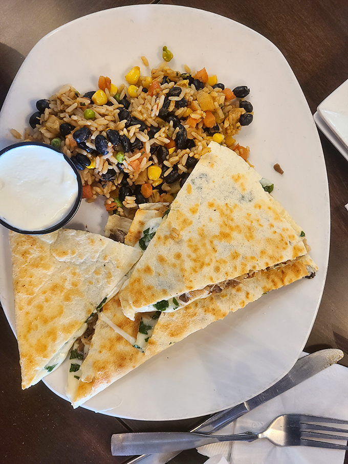 Their quesadilla comes with a side of Mexican-inspired rice that's studded with black beans and veggies – a fiesta on a plate.