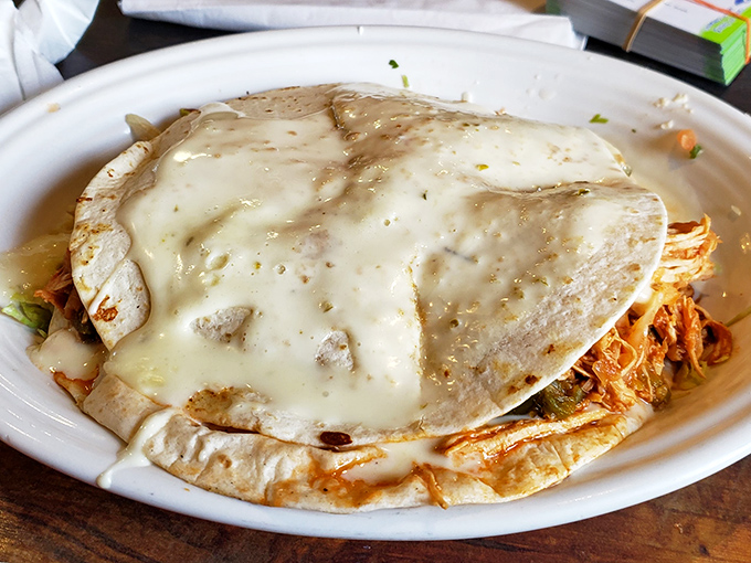 This quesadilla isn't just melted cheese between tortillas&mdash;it's a warm, gooey hug on a plate, blanketed in queso that means business.