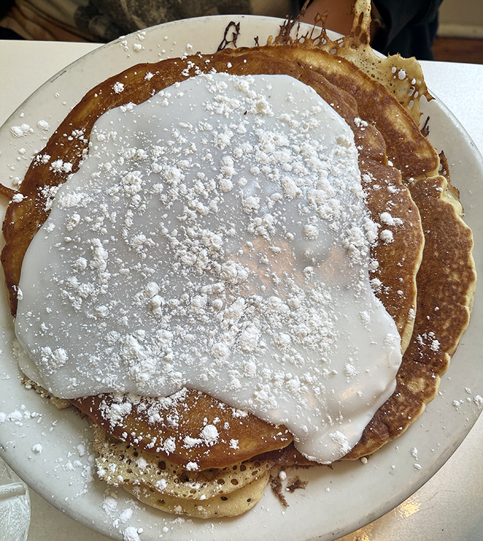 These pancakes aren't just topped with powdered sugar&mdash;they're wearing a delicate snow-white gown for their grand entrance to your table.