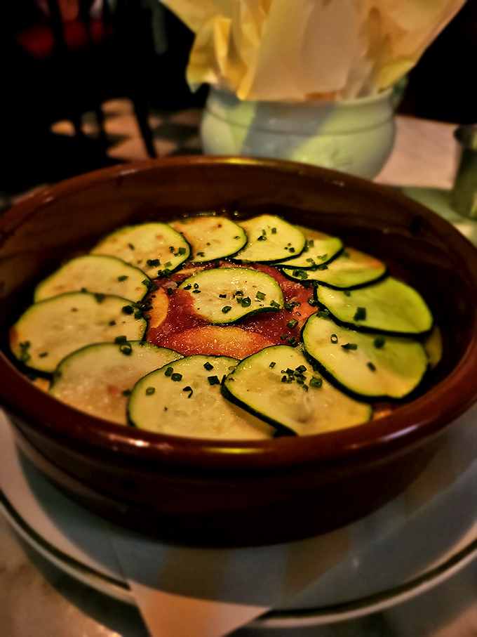 Zucchini arranged like flower petals around a tomato center—when vegetables dress up this nicely, you know they mean business.