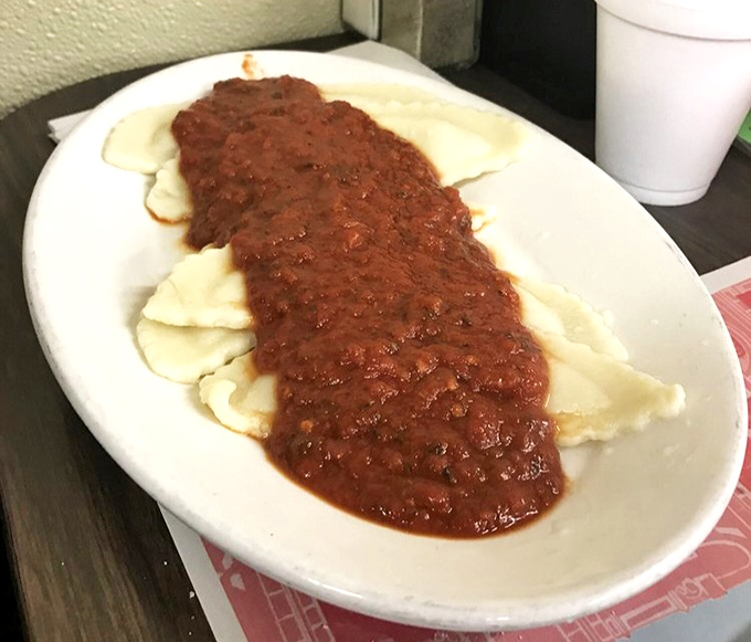 Ravioli swimming in a sea of rich, meaty sauce—the kind of comfort food that makes you want to call your mother and thank her for everything.