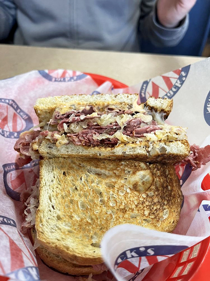 The Reuben &ndash; a towering monument to corned beef perfection where every bite delivers that magical dance of meat, kraut, and melted Swiss.