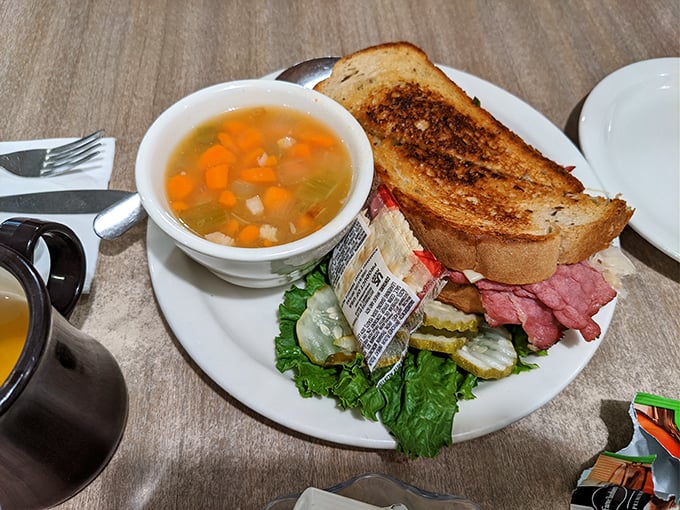 The legendary Reuben in its natural habitat, accompanied by vegetable soup. This sandwich doesn't need Instagram filters to look this good.