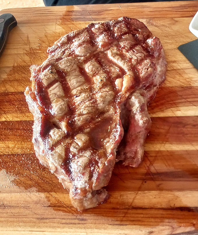 A ribeye with grill marks so perfect they could teach geometry. This isn't just steak&mdash;it's meat architecture with a PhD in flavor.