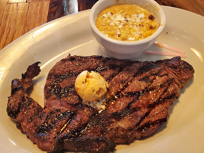 This ribeye with its pat of butter slowly melting into beefy perfection is what food dreams are made of. The corn pudding isn't just a side&mdash;it's a co-star.