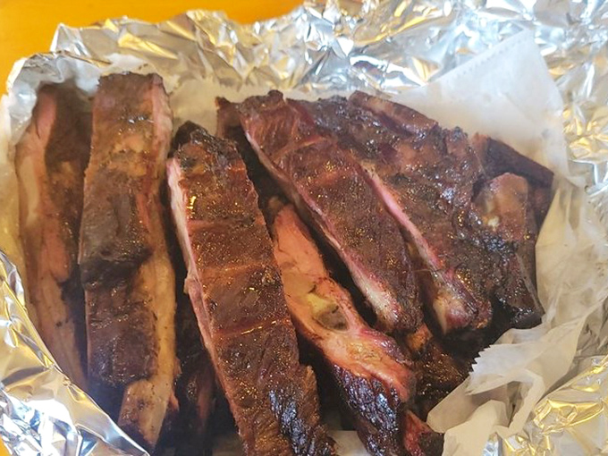 These ribs showcase the perfect bark-to-meat ratio—not falling off the bone (that's overcooked, folks) but surrendering with just the right amount of resistance.