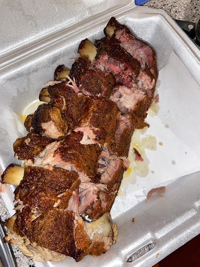 These ribs showcase that perfect mahogany bark with a pink smoke ring that whispers sweet nothings about hours spent in the smoker's embrace.