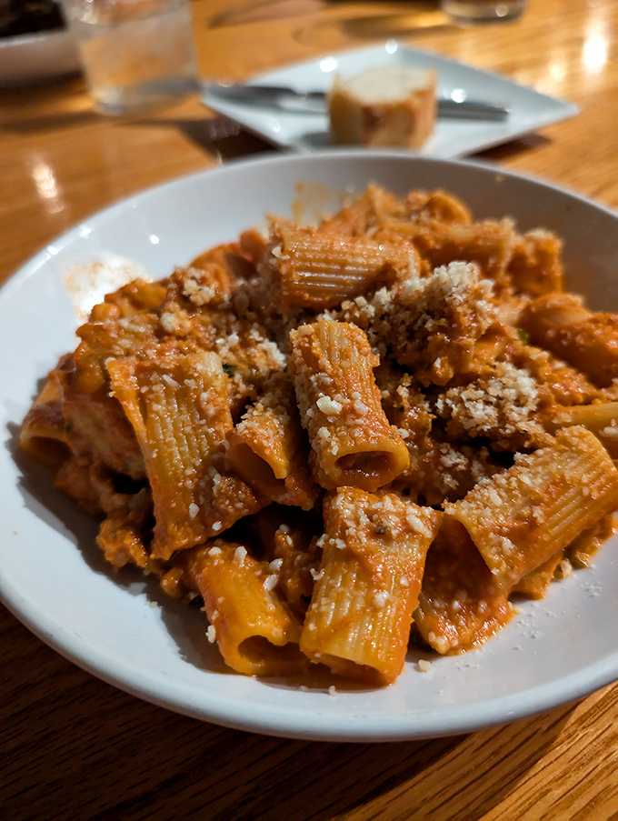 Rigatoni that doesn't just sit on the plate but stands at attention, each tube a perfect vessel for that robust sauce demanding to be savored.