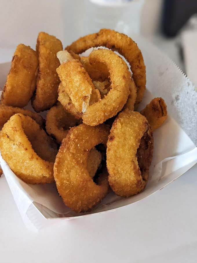 These golden onion rings aren't just side dishes &ndash; they're crispy halos of happiness that deserve their own moment of silence.