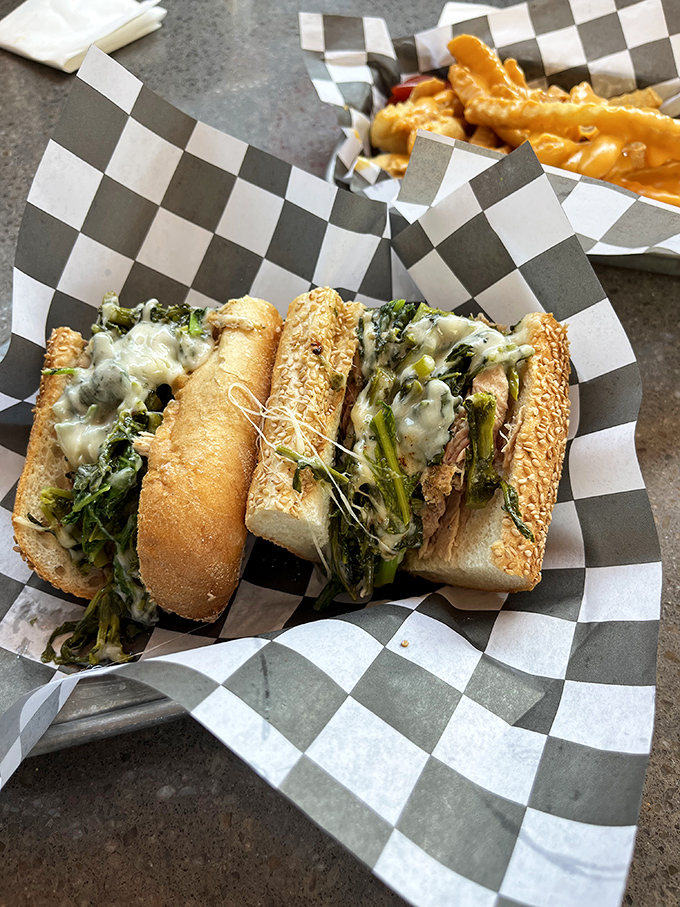 A proper Philly sandwich demands proper construction: crusty roll, perfectly balanced fillings, and enough heft to make you grateful for the checkered paper.