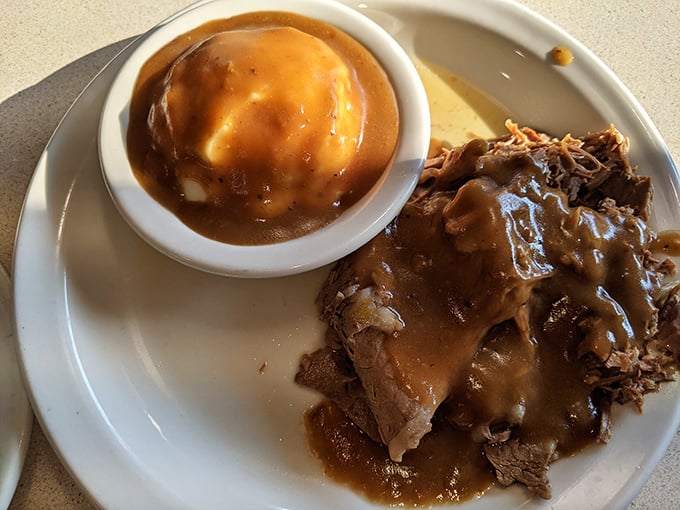 Roast beef and mashed potatoes swimming in gravy—the kind of plate that makes you want to call your cardiologist and apologize in advance.