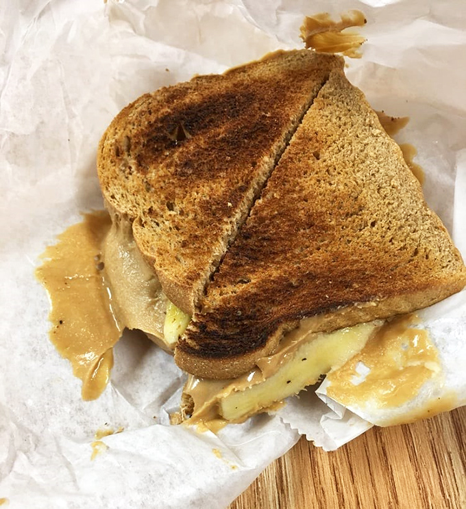 This isn't just a sandwich; it's edible nostalgia with a gourmet twist. That toasted bread and melty peanut butter combo is what dreams are made of.