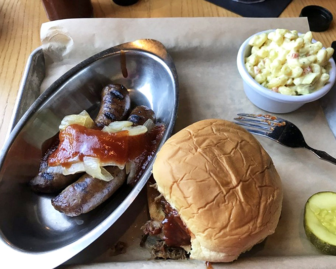The holy trinity of BBQ happiness: sausage, sandwich, and potato salad. Notice how the pickle stands guard, ready to cut through all that richness.