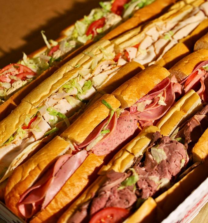 A lineup of sandwiches that would make a food photographer's career. This isn't lunch – it's edible architecture with attitude.