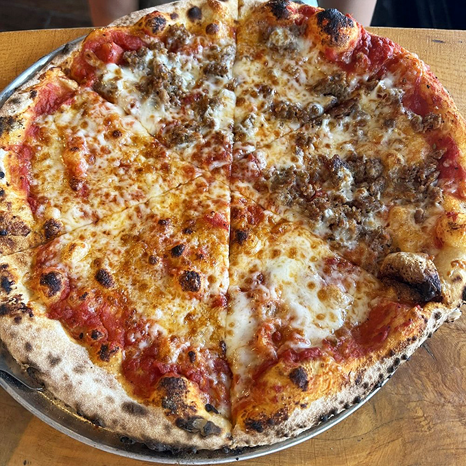 A perfectly blistered crust cradles that ideal ratio of sauce, cheese, and sausage&mdash;proof that a well-made sausage pizza, executed flawlessly, is revolutionary.