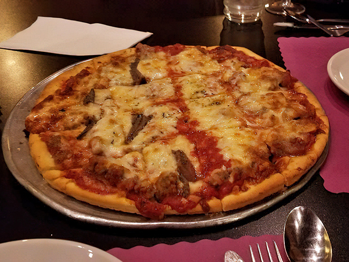 Pizza perfection doesn't need fancy toppings&mdash;just a perfectly balanced sauce, melty cheese, and sausage that would make any nonna nod in approval.