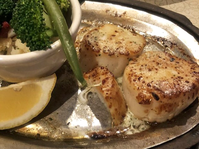 These scallops are seared to golden perfection, proving seafood has a place in steakhouse heaven.