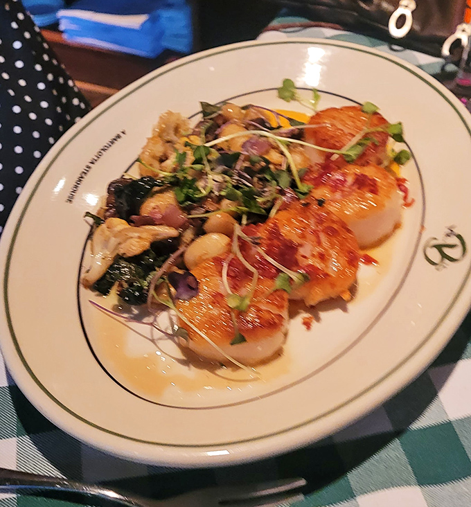 These scallops aren't just seared&mdash;they're transformed into buttery medallions of the sea, paired with vibrant vegetables that sing harmony.