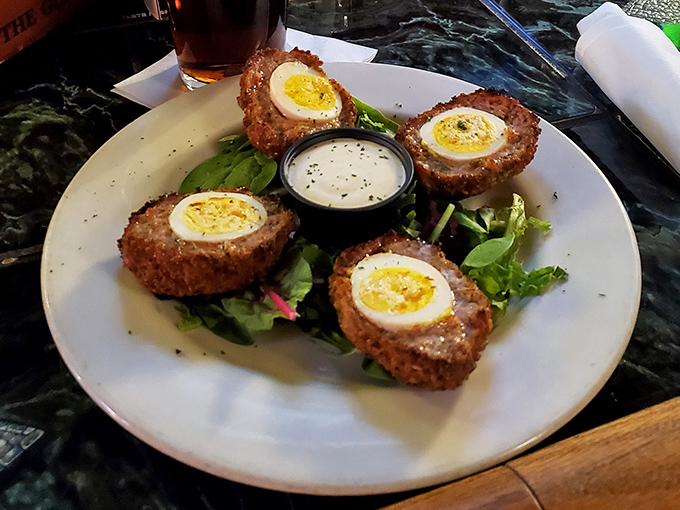 Scotch eggs done right &ndash; crispy exterior giving way to savory sausage and that perfect soft-boiled center. Pub food elevated beyond bar snack to culinary art form.
