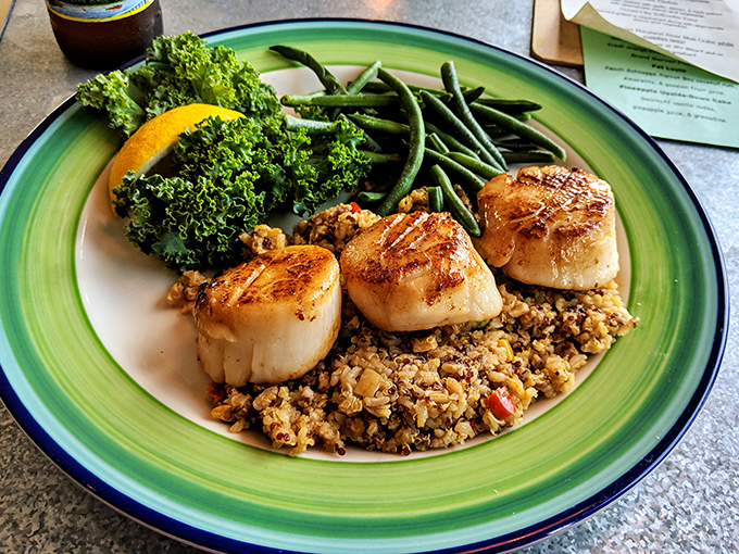 Perfectly seared scallops that would make Neptune himself weep with joy, served atop rice that's soaked up all the right flavors.