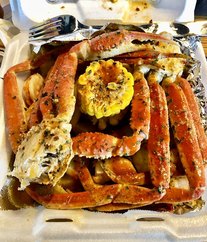 Crab legs arranged like nature's perfect architecture, surrounding a bright yellow corn centerpiece. This is what seafood dreams are made of, Tennessee style.