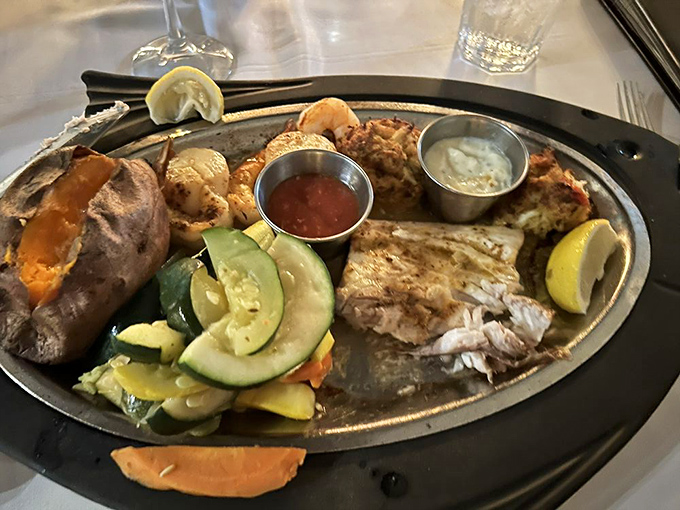 When indecision strikes, this seafood platter delivers a greatest hits album of ocean treasures alongside a perfectly baked potato and fresh vegetables.
