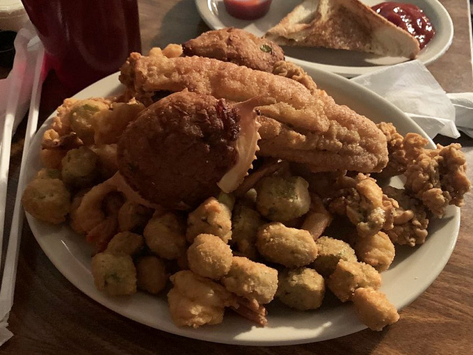 The seafood platter that answers the eternal question: "Why choose one when you can have it all?" Those hushpuppies are little orbs of joy.