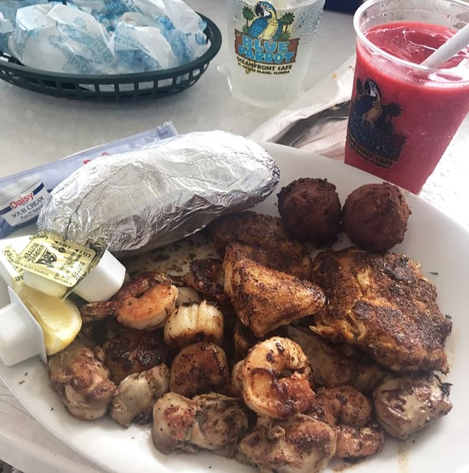 Blackened perfection meets Gulf shrimp in a plate that whispers, "Cancel your afternoon plans." That red drink isn't optional&mdash;it's essential.