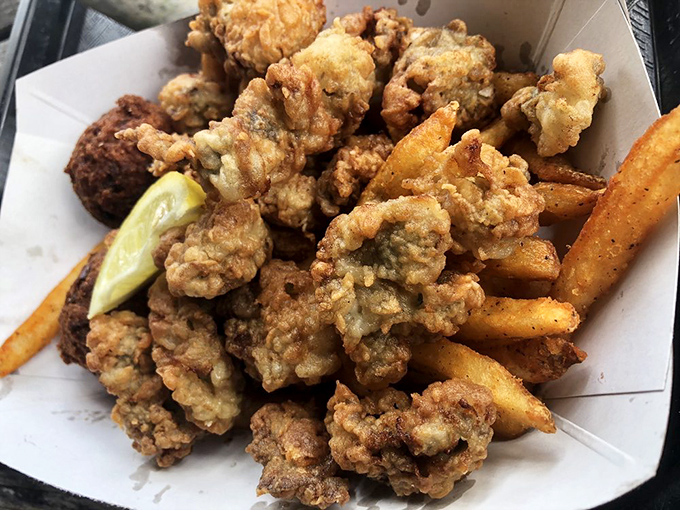 Golden-fried seafood and crispy fries create a basket of joy that makes paper plates look like fine china. Diet plans surrender at first sight.