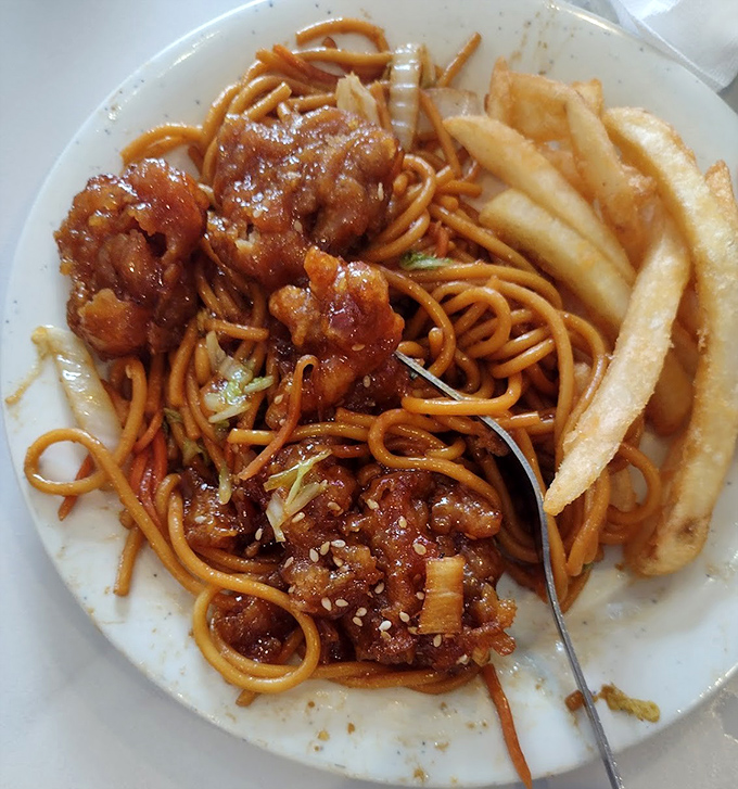 Lo mein noodles tangled with sesame chicken and fries&mdash;the buffet equivalent of "why choose when you can have it all?"