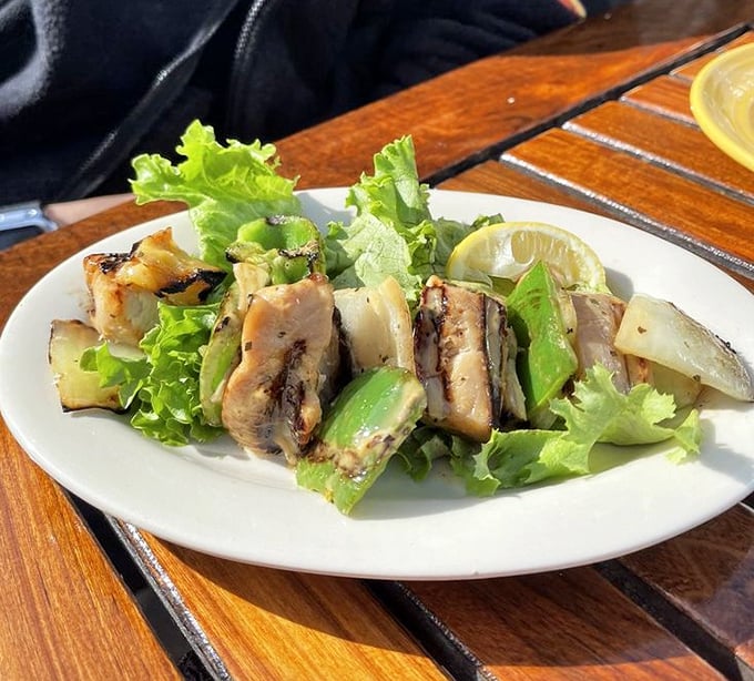 Grilled shark kabobs that would make Jaws reconsider his diet plan, served with fresh veggies and a squeeze of citrus.