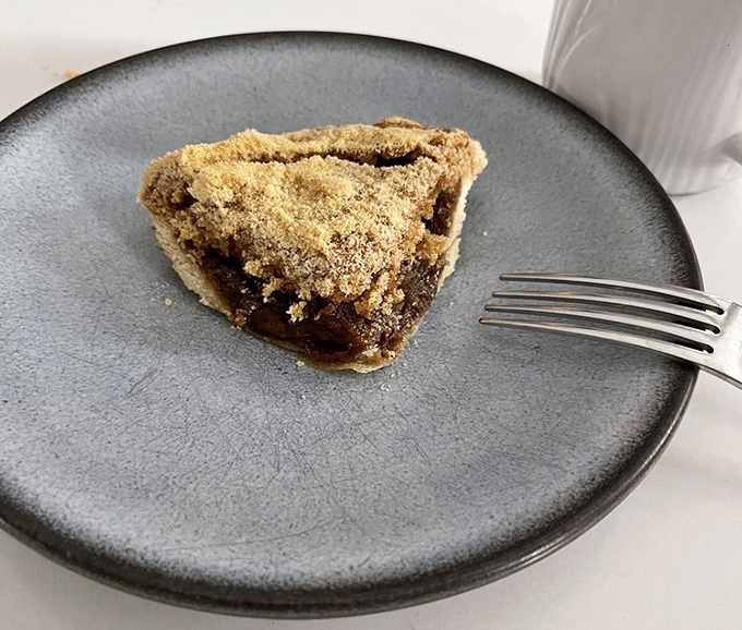 Shoofly pie on a gray plate—where molasses meets crumb topping in a marriage so perfect it should have its own reality show.