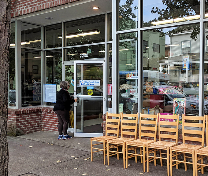 The daily pilgrimage begins. Those wooden chairs outside suggest even the furniture is eager to find a new home.