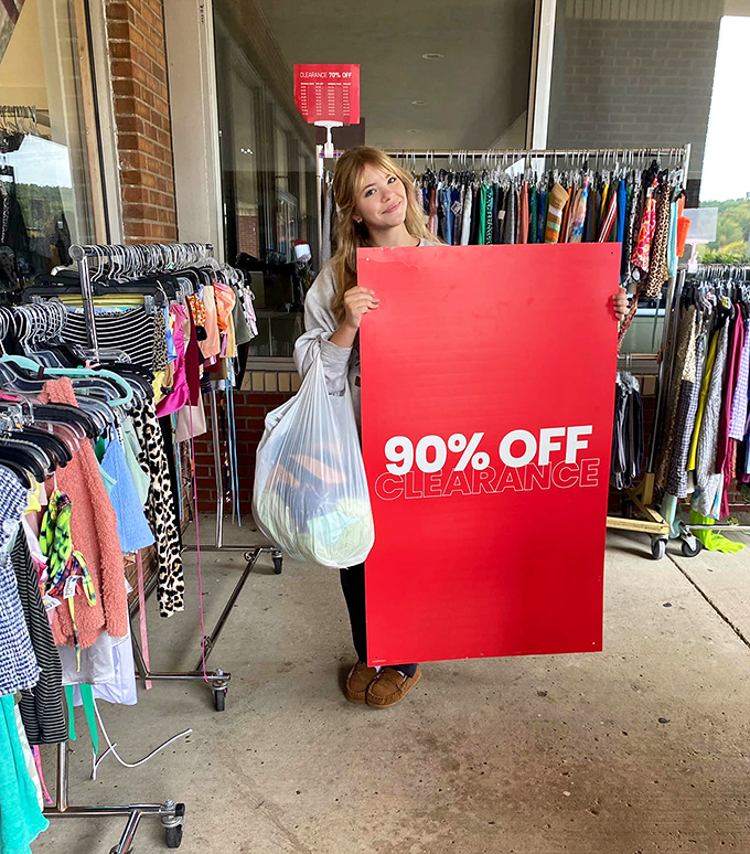 When the clearance sign says 90% OFF, you don't walk—you run. This shopper's smile says it all: victory achieved.