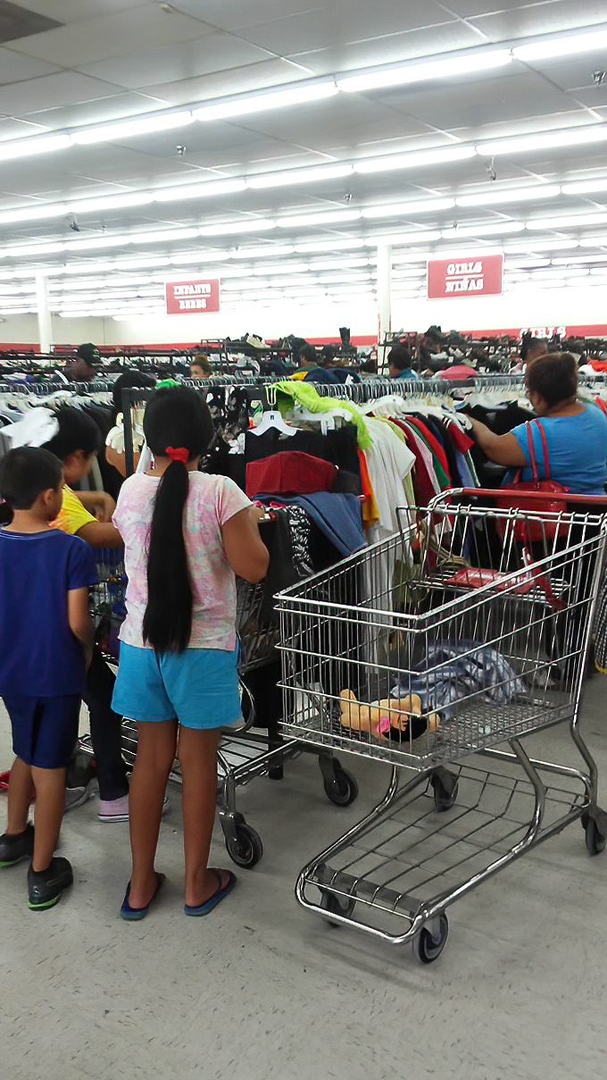 The serious art of thrifting in action. Notice the strategic shopping cart positioning&mdash;these aren't amateurs, folks.